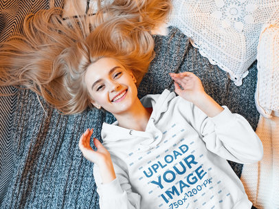 Placeit - Pullover Hoodie Mockup of a Cheerful Woman Lying on a Bed
