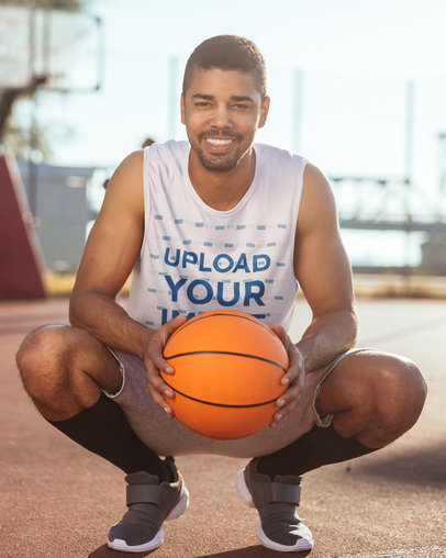 Placeit - Tank Top Mockup of a Smiling Basketball Player Man Holding a Ball