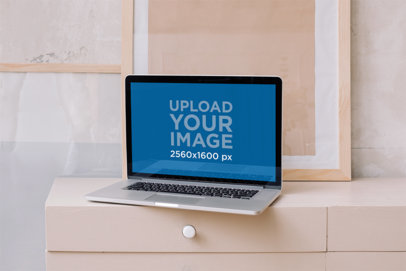 Placeit - Mockup of a MacBook on a Peach-Colored Desk