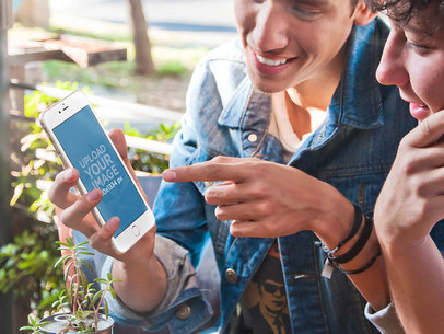Placeit - iPhone Mockup of Two Friends Holding an iPhone 6