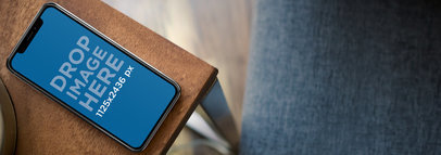 Placeit - iPhone 11 Pro Mockup on the Corner of a Wooden Table