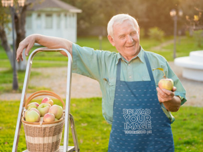Placeit - Apron Mockup of a Smiling Senior Man Picking Up Apples