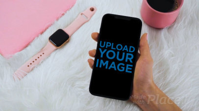 Placeit - Video of a Woman Holding an iPhone 12 Pro Max in Her Hand