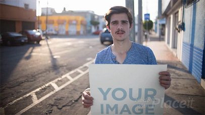 Placeit - Dude Sticking a Poster to a Wall In The Street Stop Motion Mockup
