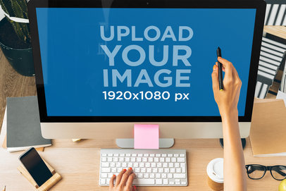 Placeit - iMac Mockup Featuring a Woman's Hand Pointing at the Screen ...