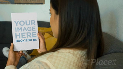 Placeit - Over Shoulder Video of a Pretty Woman Taking a Look at a Book