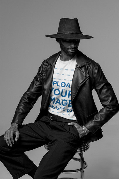 Placeit - Tee Mockup of a Stylish Man Sitting on a Stool at a Studio