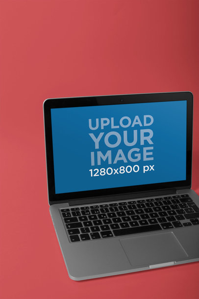 Placeit - MacBook Mockup on a Solid Color Surface with an Angled Shot