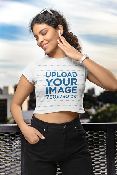 Placeit - Gildan Crop Top Mockup of a Smiling Woman Posing in a Balcony