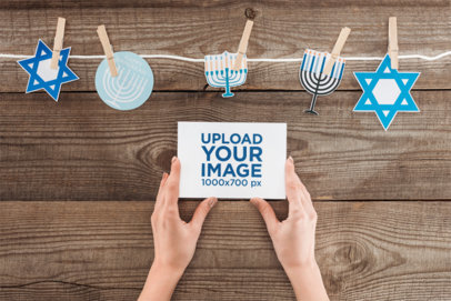 Placeit - Hanukkah-Themed Mockup Featuring a Person Holding a Flyer