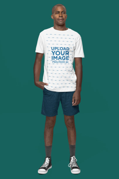 Placeit - Mockup of a Man Standing in a Studio Wearing a Next Level T-Shirt