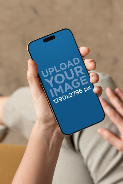 Placeit - Mockup of a Woman Holding an iPhone 15 Pro Max in Her Hand