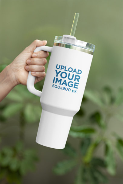 Placeit - Mockup of a Person Holding a Stanley Tumbler