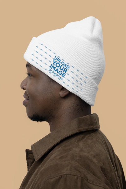 Placeit - Side-View Yupoong Beanie Mockup Featuring a Man in a Studio