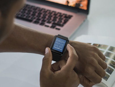 Placeit - Young Man Using His Apple Watch While Studying