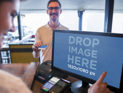 Placeit - Mockup of a Young Cashier Using PC Desktop for Sales Transaction