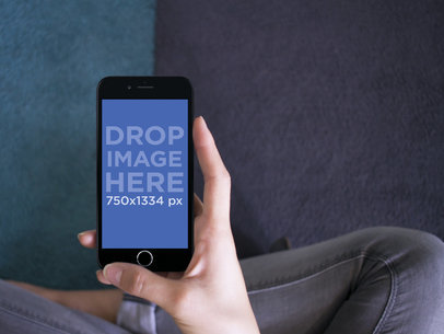 Placeit - Mockup of Woman Sitting Cross Legged and Using her iPhone