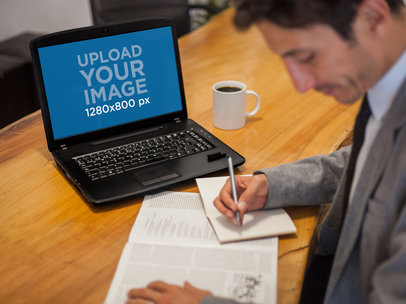 Placeit - Laptop Mockup Featuring a Businessman at the Office Working ...