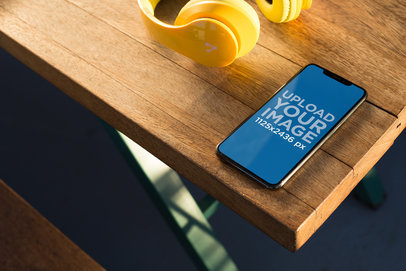 Placeit - Mockup of an iPhone 11 Pro Resting on a Wooden Table