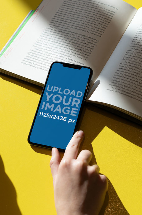 Placeit - iPhone 11 Pro Mockup over an Open Book
