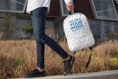 Placeit - Mockup of a Teen Holding a Backpack with One Hand