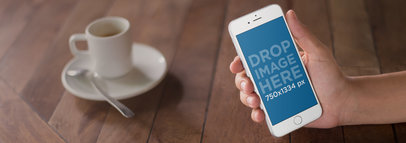 Placeit - iPhone Mockup of a Man Having a Coffee at a Local Cafe