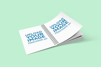 Placeit - Mockup Featuring an Opened Spiral Notebook Lying Against a ...