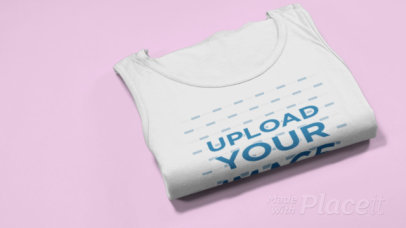 Placeit - Video of a Folded Tank Top Placed on a Surface by Someone