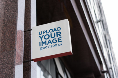 Placeit - Mockup of a Sign Attached to a Tall Building