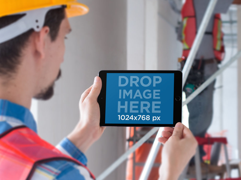 Placeit - Mockup of a Construction Worker Holding an iPad in Landscape ...