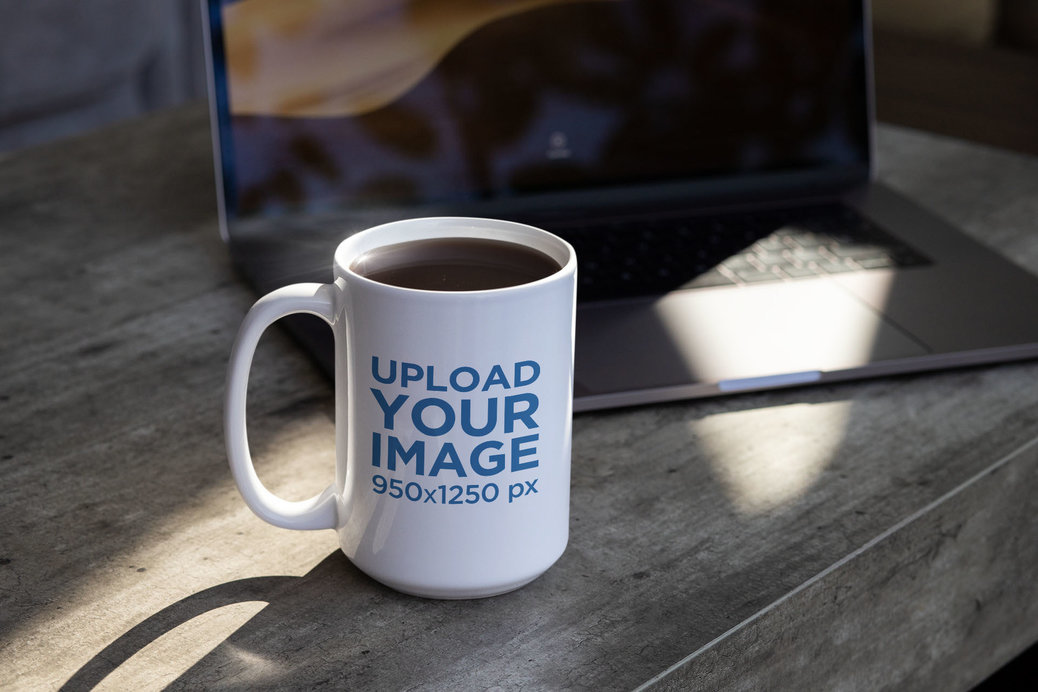 Placeit - Mockup of a Sticker on a Coffee Mug Beside a Laptop