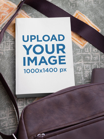 Placeit - Mockup Featuring a Paperback Book Placed by a Bag