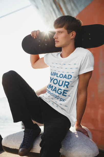 Placeit - T-Shirt Mockup of a Cool Man Posing with a Skateboard