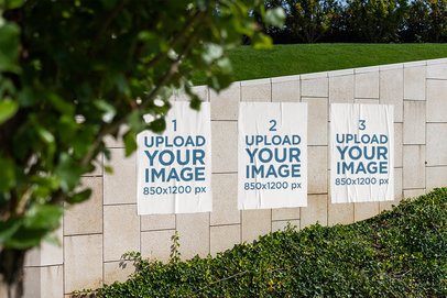 Placeit - Mockup of Three Paper Posters on a Wall