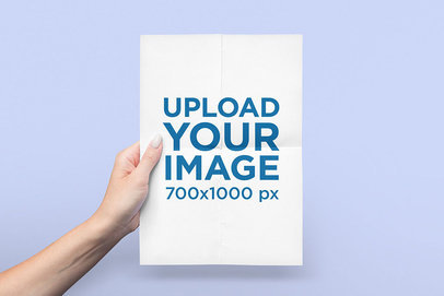 Placeit - Mockup Featuring a Woman's Hand Holding a Vertical Flyer