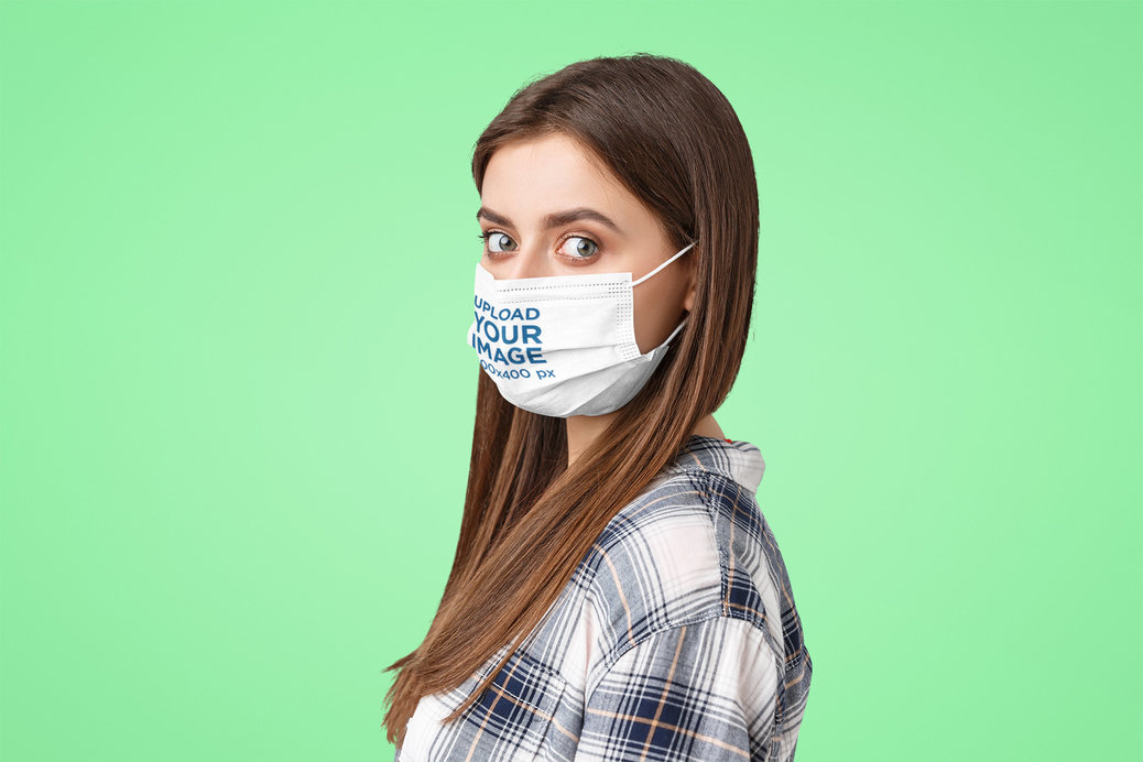 Placeit - Face Mask Mockup Featuring a Doe-Eyed Woman in a Studio