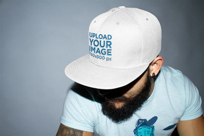 Placeit - Mockup of a Bearded Man Wearing a Snapback Hat