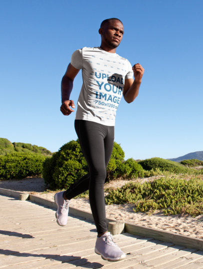 Placeit - T-Shirt Mockup of an Athlete Running on a Sandy Track