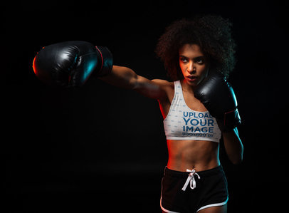 Placeit - Sports Bra Mockup of a Woman Boxing in a Dark Room