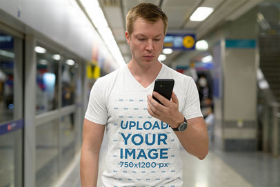 Placeit - T-Shirt Mockup of a Man Looking at His Phone at the Subway ...