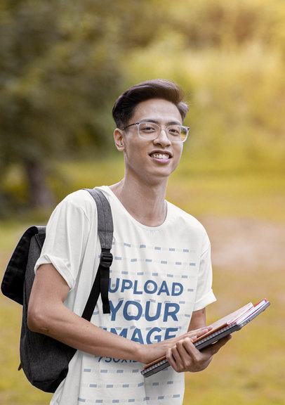 Placeit - T-Shirt Mockup of a Student in a Campus with Nature