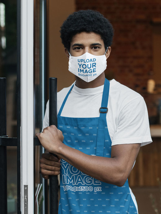 Placeit - Apron and Face Mask Mockup Featuring a Curly-Haired Man