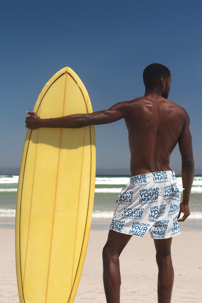 Placeit - Back View Mockup of a Man Wearing Swim Trunks at the Beach