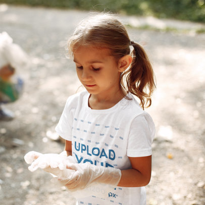 Placeit - T-Shirt Mockup of a Little Girl Wearing Plastic Gloves