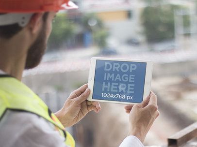 Placeit - iPad Mini Mockup of an Onsite Construction Worker