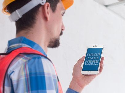 Placeit - Mockup of a Construction Worker Holding an iPhone 6 in ...