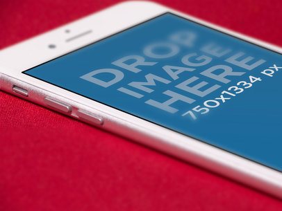 Placeit - iPhone Angled Close Up Mockup Lying Over a Red Surface